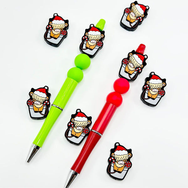 Little Cute Highland Cow in a Red Christmas Hat Sits in a Bucket Barre ...